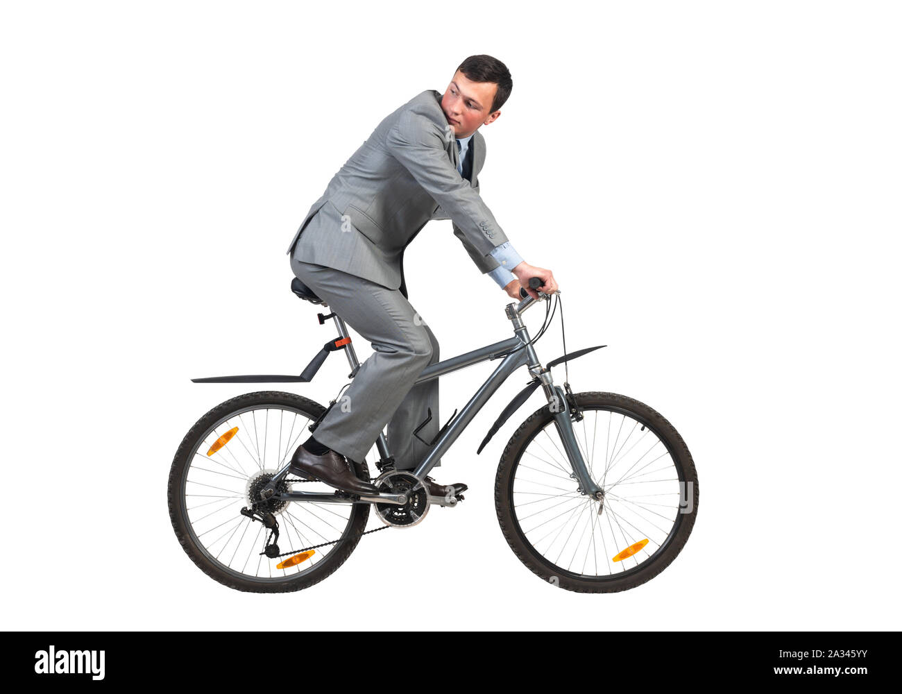 Young man in grey business suit on bike. Handsome businessman riding ...