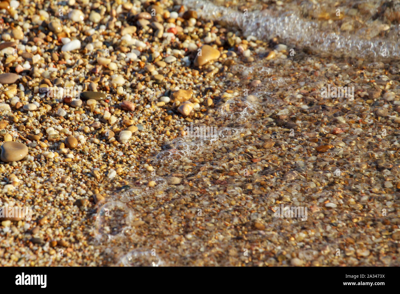 sea pebbles colored granite on the beach background stones. The shore ...