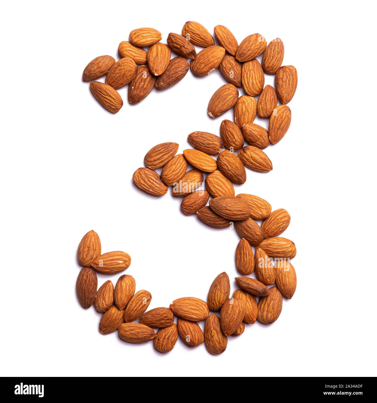 Arabic numeral "3" from a peeled almond on a white isolated background ...