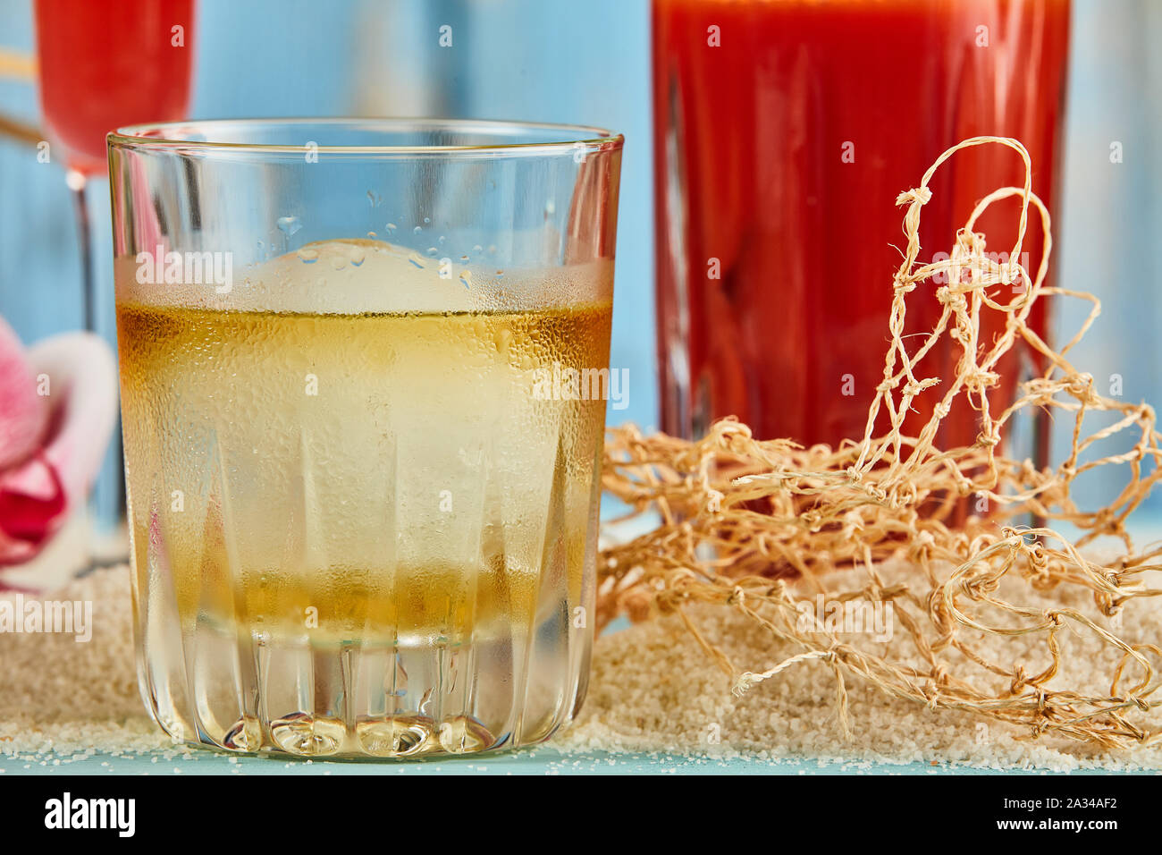Glass of ice cold whisky on the rocks in a close up view with ...