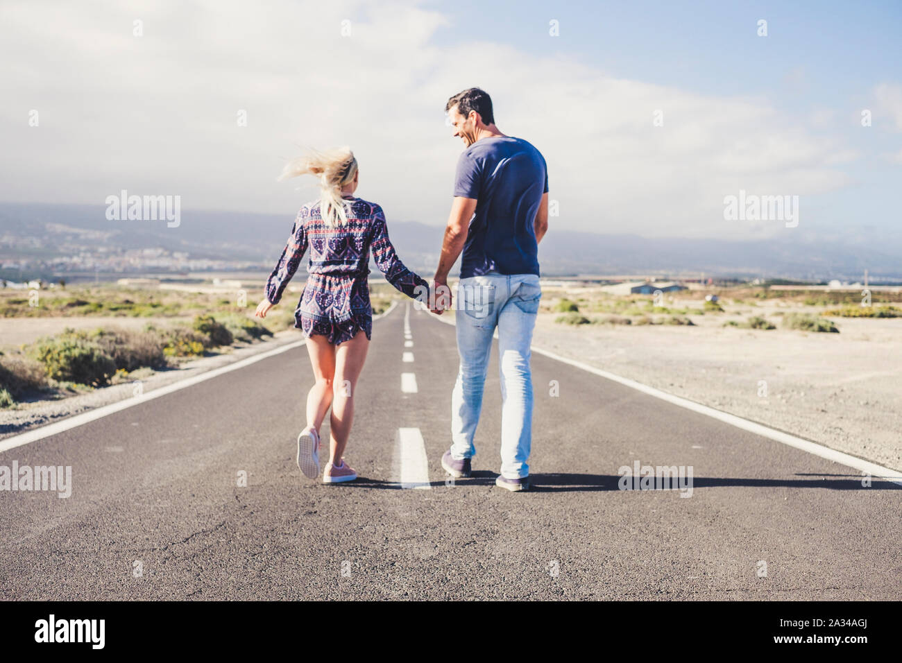 life together concept with two young people viewed from back walking ...