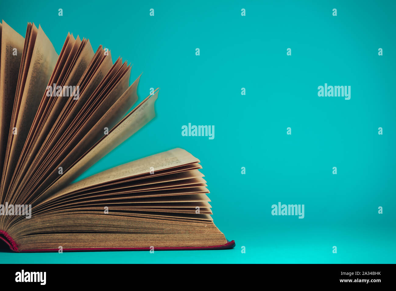 Beautiful open red book on a aquamarine background Stock Photo - Alamy