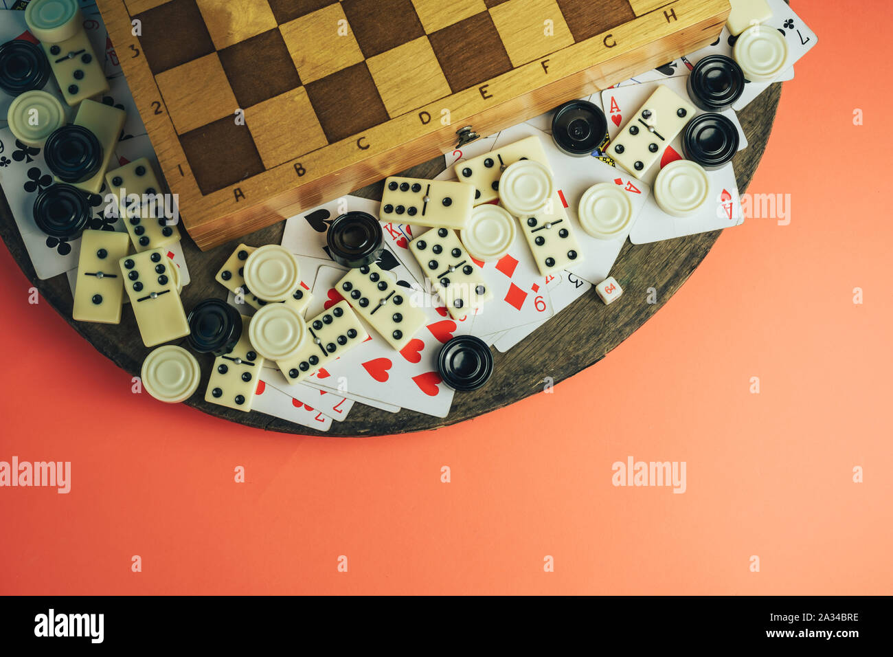 Various board games chess board, playing cards, dominoes on a old ...