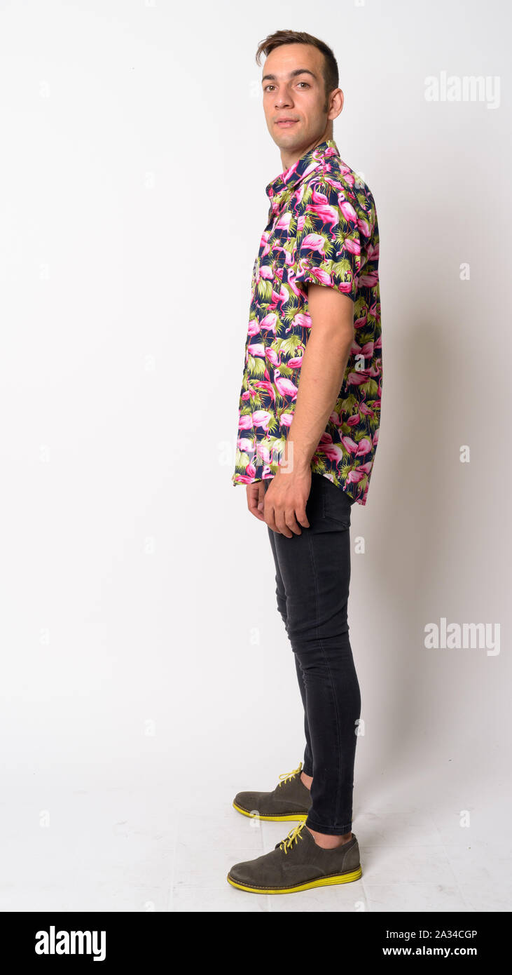 Full body shot profile view of young Persian man looking at camera ...