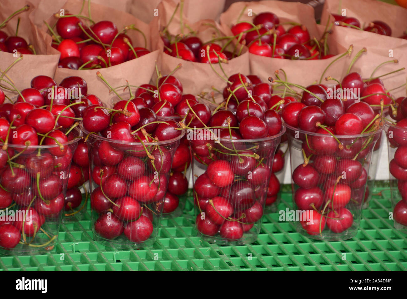 low fat cherries in plastic cups and paper bags, ready-to-eat red ripe ...
