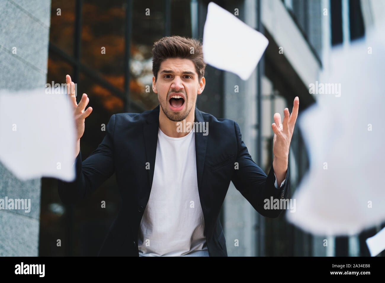 Businessman tearing contract pieces.Angry furious office worker ...
