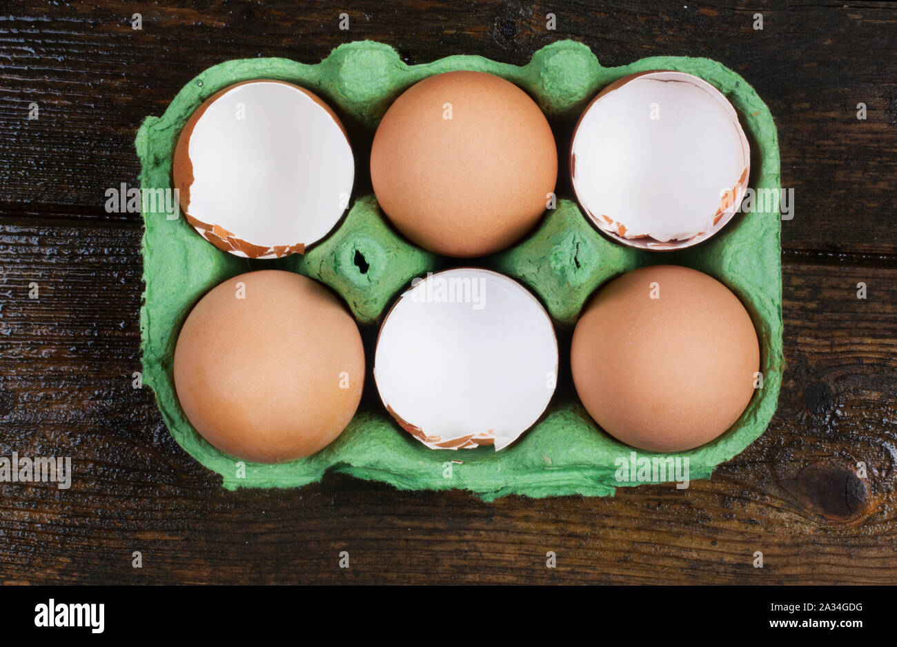 Studio shot of cracked, empty chicken egg shells in an egg box on a ...