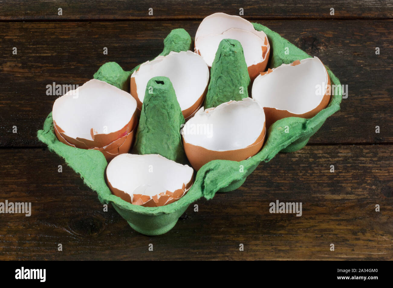 Studio shot of cracked, empty chicken egg shells in an egg box on a ...