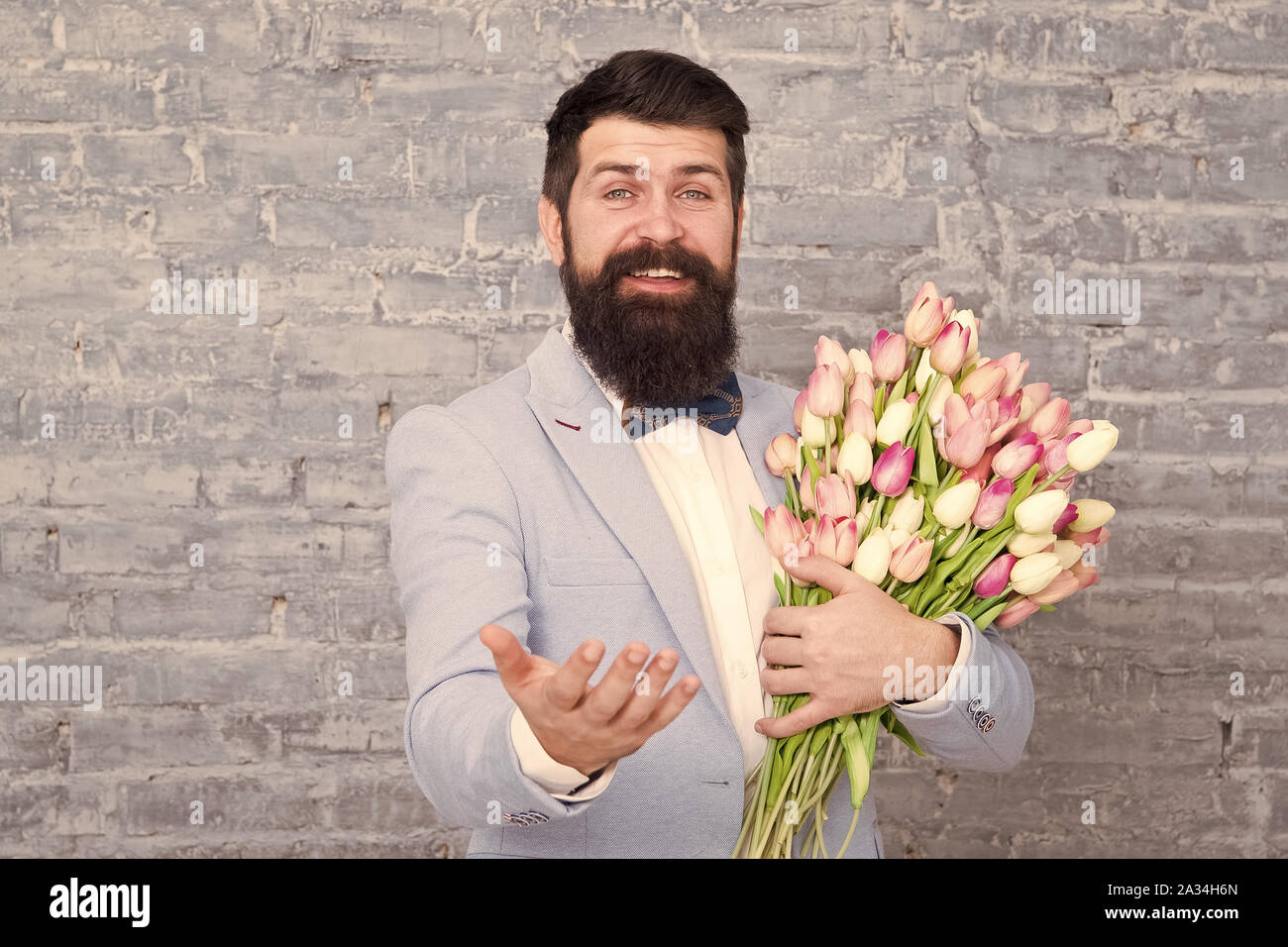 Romantic man with flowers. Romantic gift. Macho getting ready romantic ...