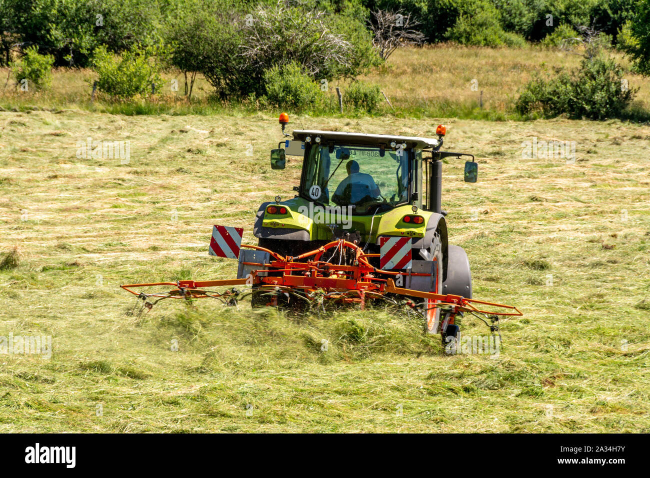 Tractor cutting silage Stock Photo - Alamy