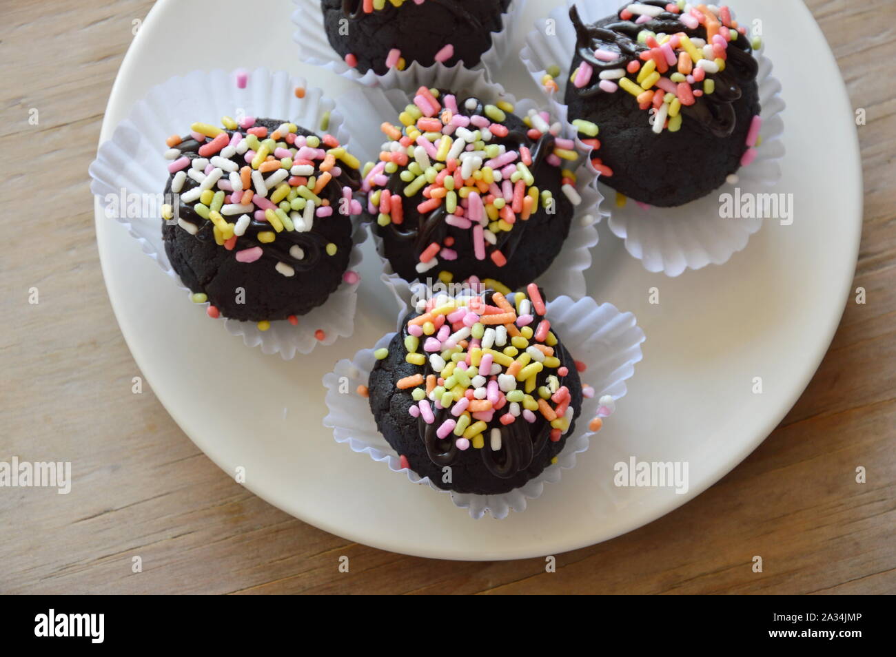 chocolate ball cake topping colorful candy in paper tray Stock Photo ...