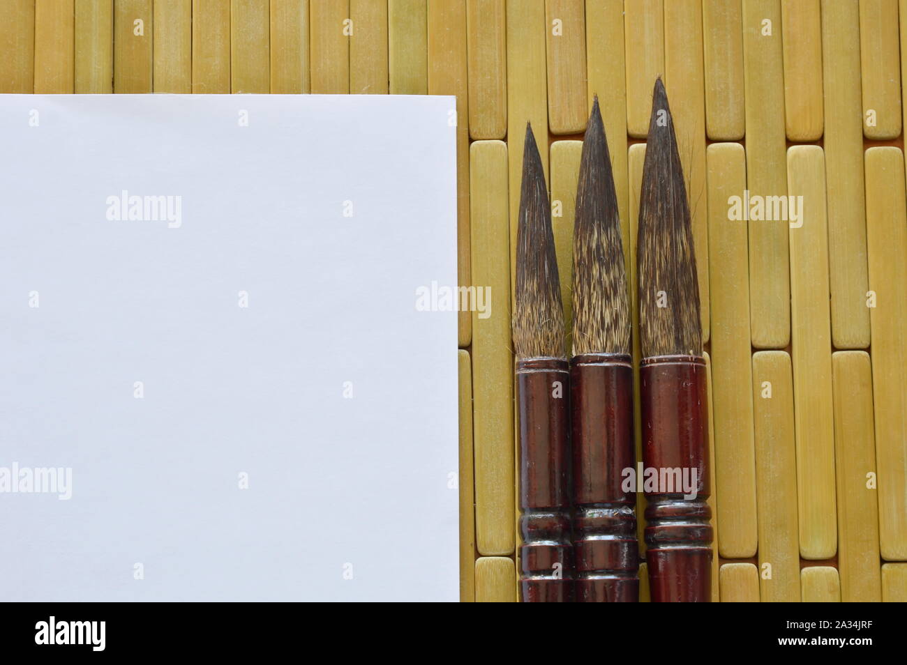 Chinese calligraphy variety size and white paper on bamboo Stock Photo ...