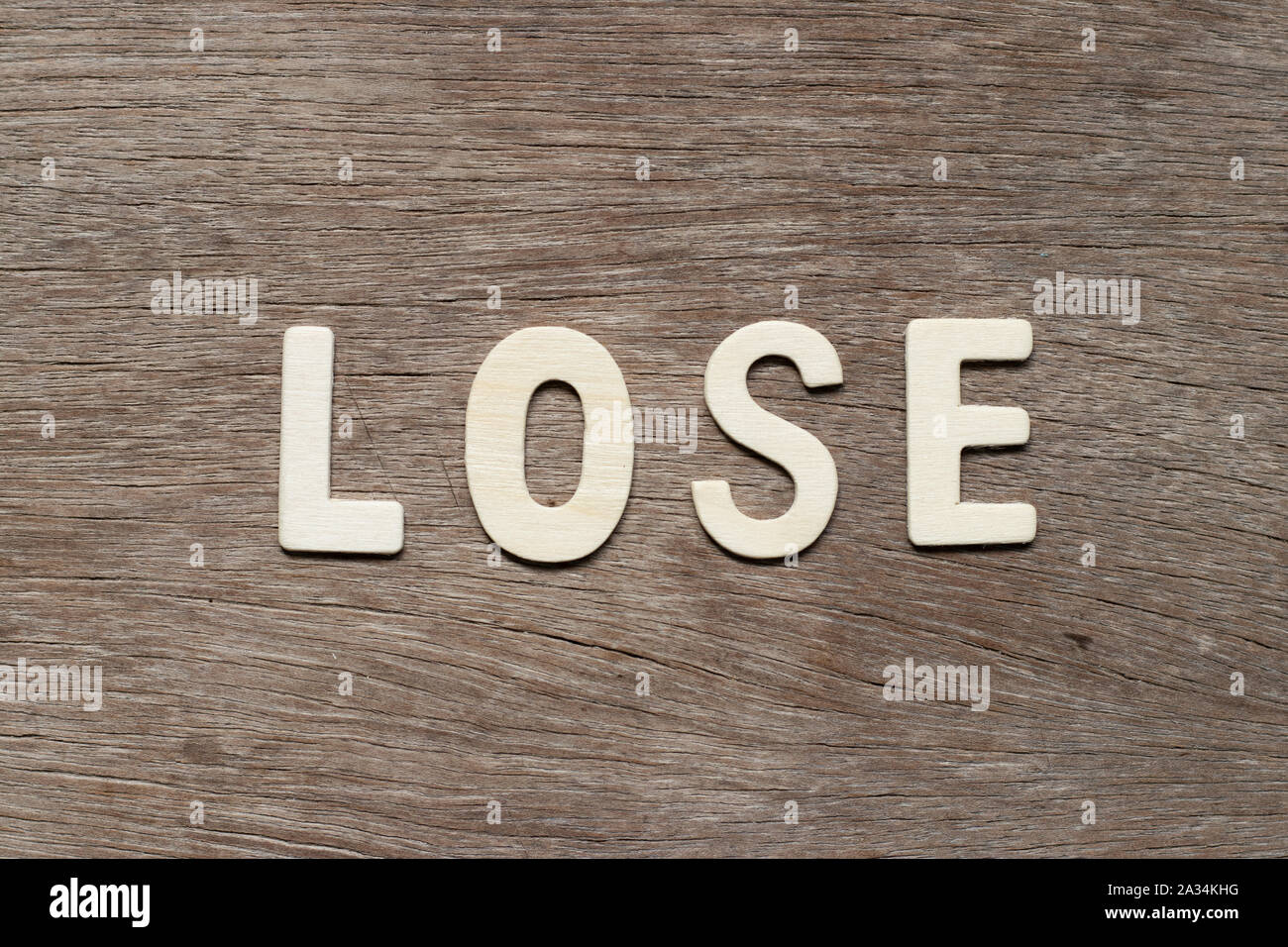 Alphabet letter in word lose on wood background Stock Photo - Alamy