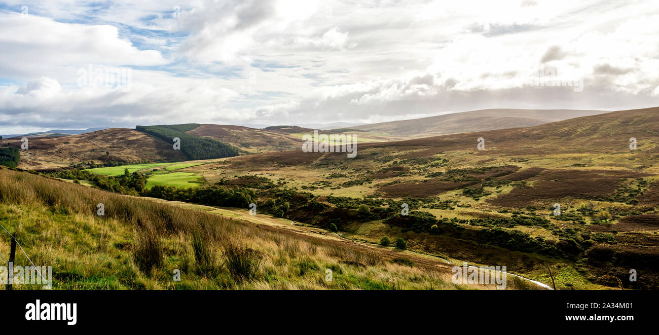 A scenic colourful landscape of a small valley surrounded by small ...