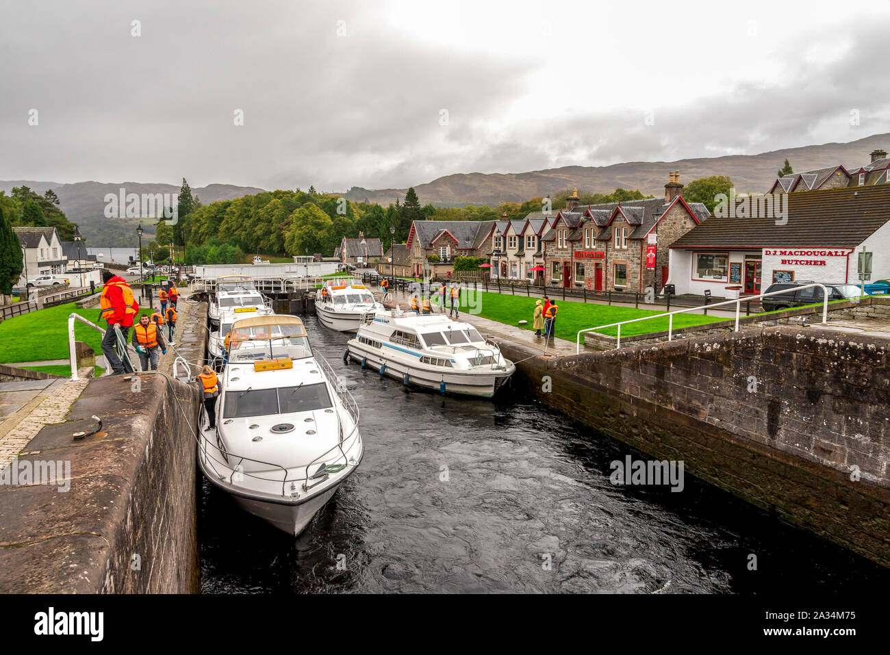 Boats parked between the locks and people waiting to enter the ...