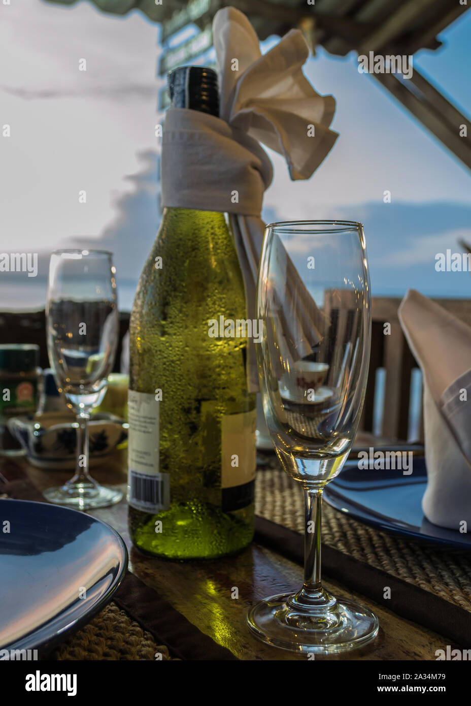 Setting dining table with white wine in the evening Stock Photo - Alamy