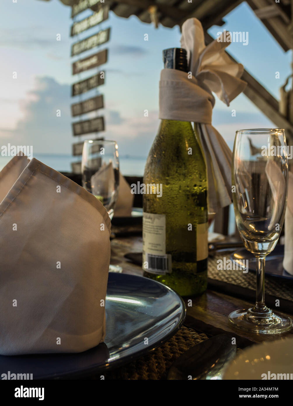 Setting dining table with white wine in the evening Stock Photo - Alamy