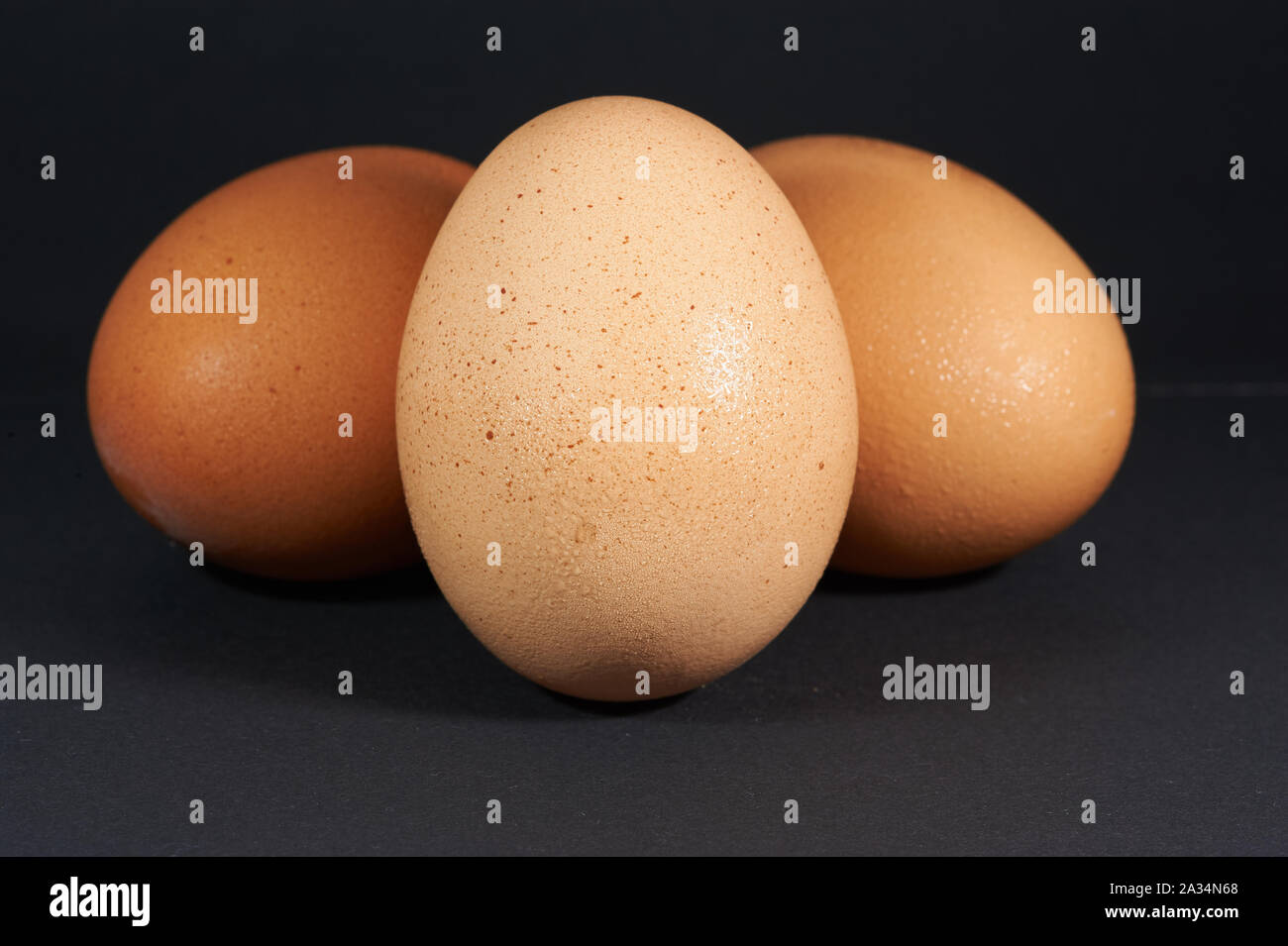 Three eggs in black background special for presentation Stock Photo - Alamy