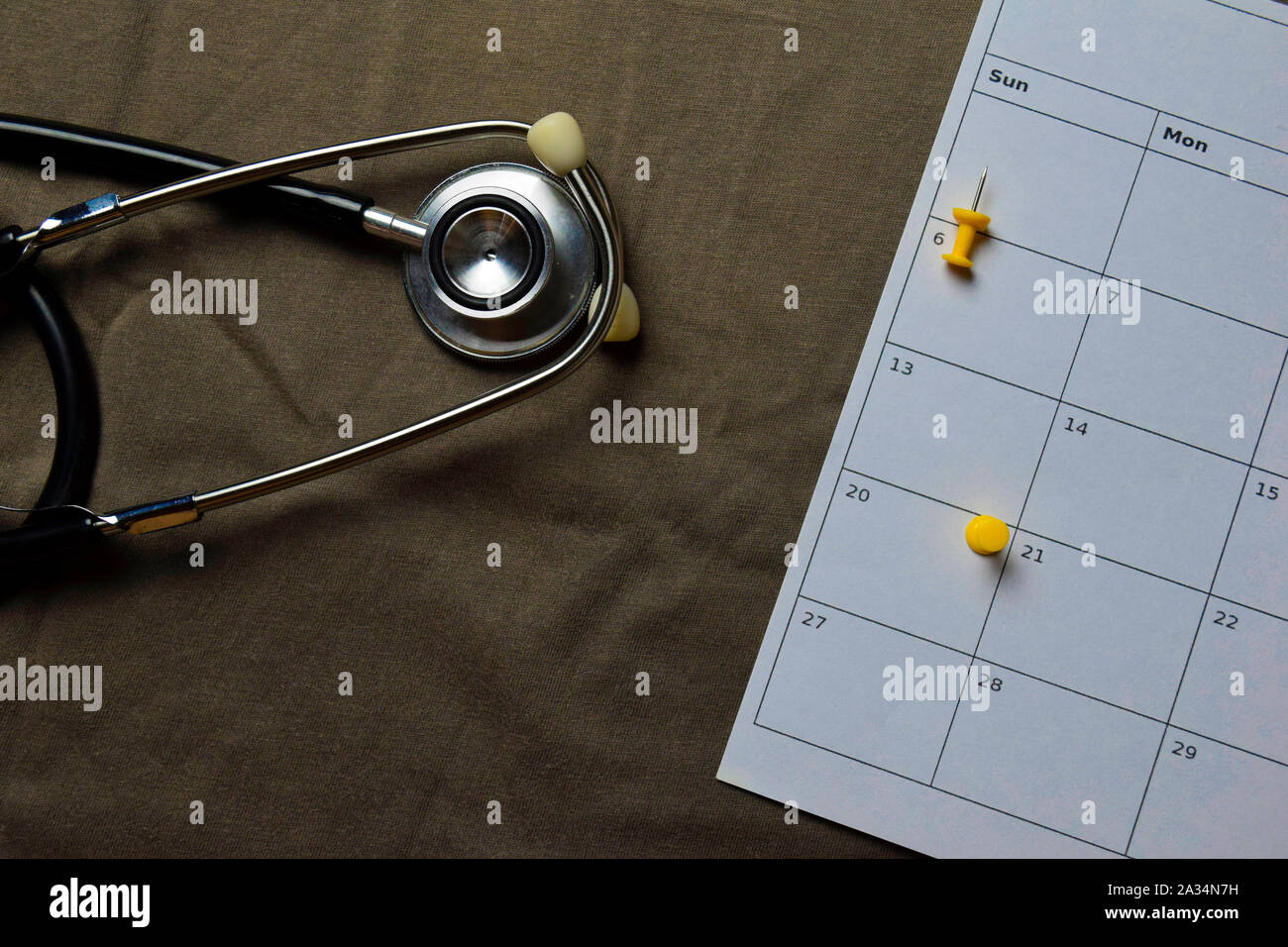 Close up stethoscope and stiky notes on a calendar. Schedule or Medical ...