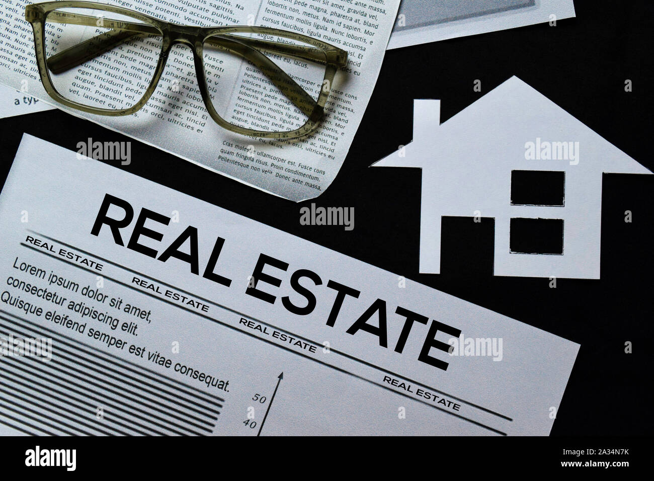 Real Estate text in headline isolated on black background. Newspaper ...