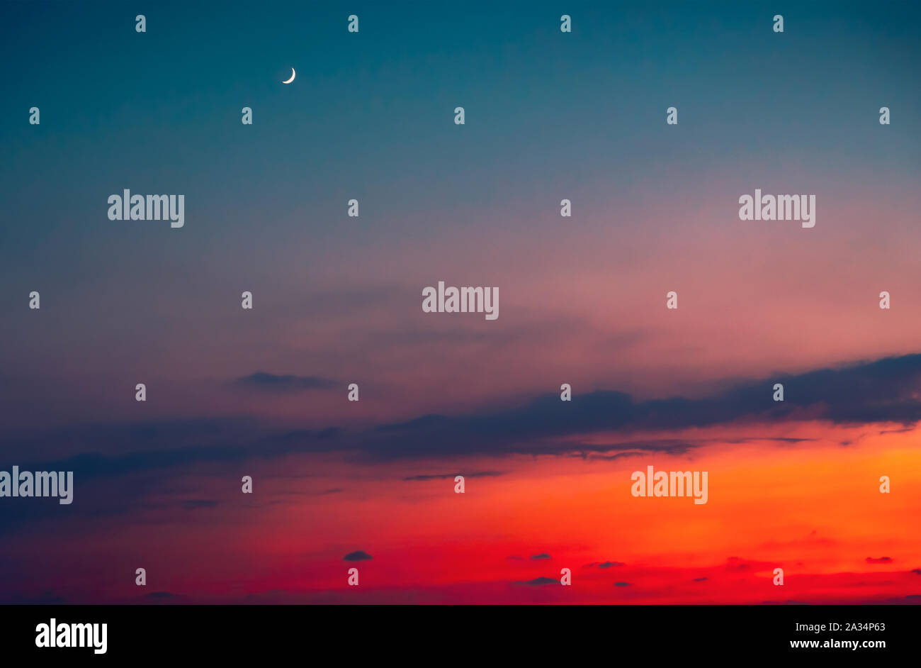 Amazing sunset, beautiful red skyscape with new moon, beauty of moon ...