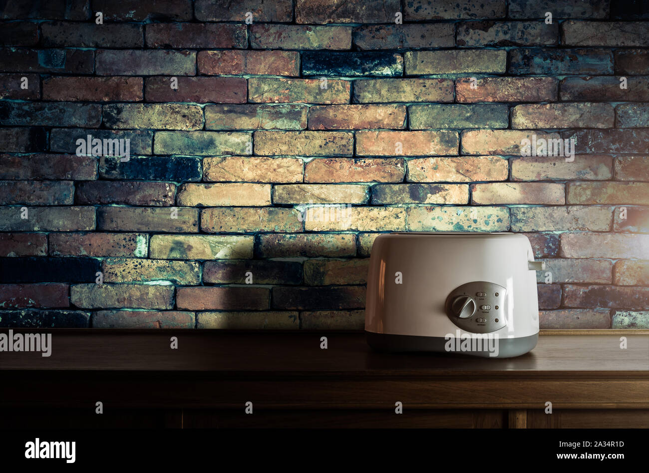 White toaster on wooden cupboard in kitchen room with vintage brick ...