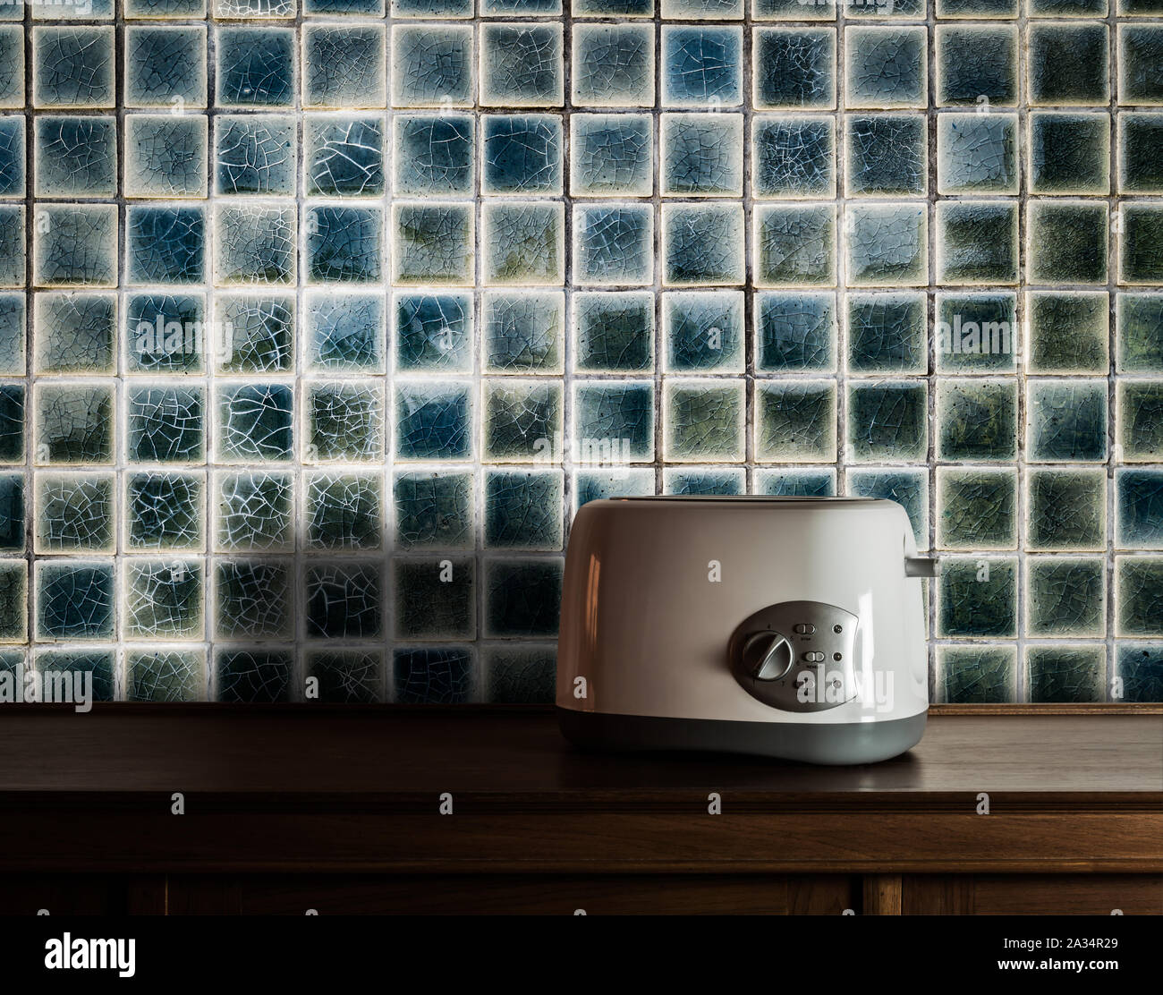 Toaster on wooden cupboard in kitchen room with vintage tiles wall ...