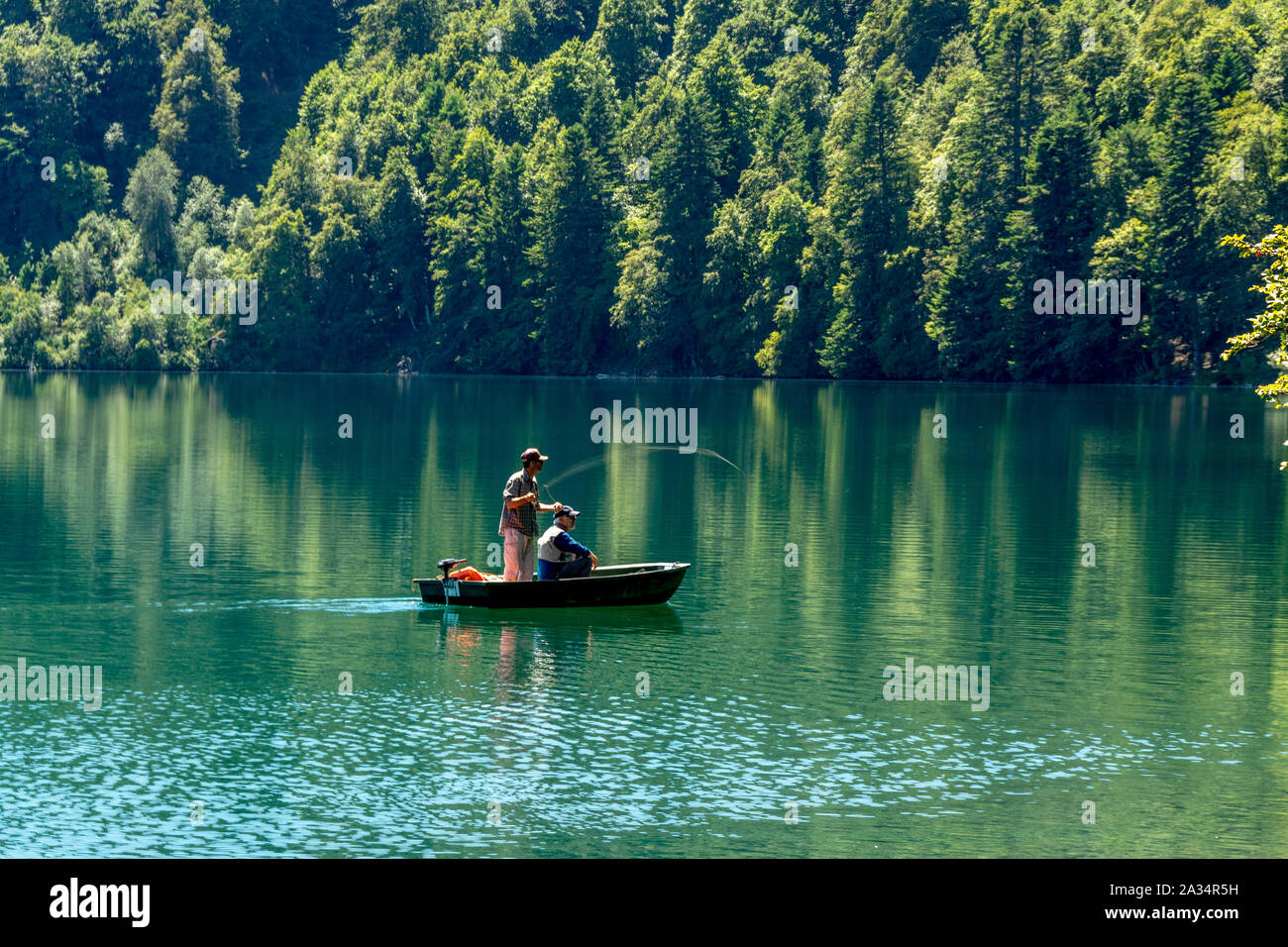 Fishing in volcanic Pavin lake located in the Regional Natural Park of ...