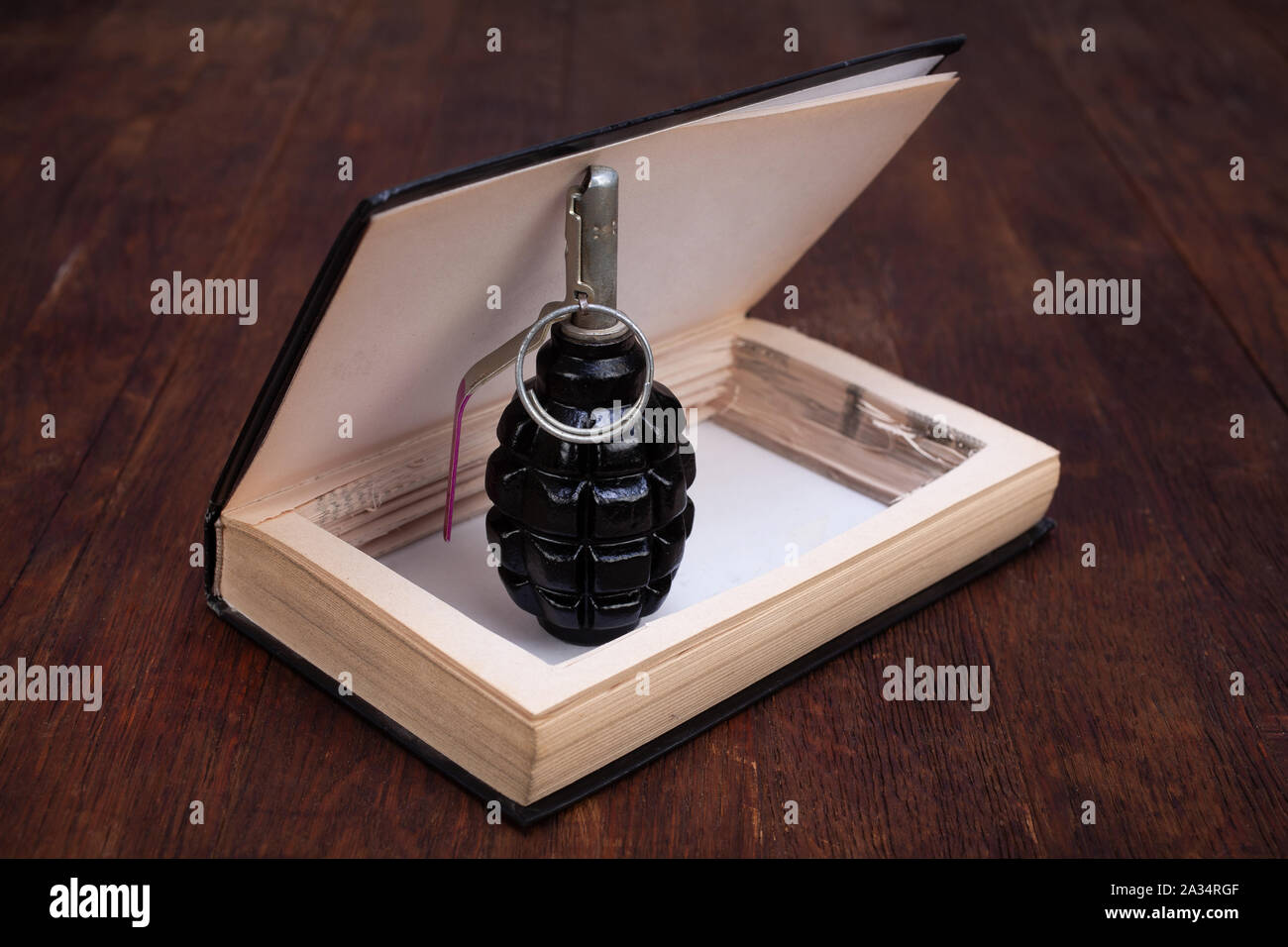 Gun hidden in book hi-res stock photography and images - Alamy