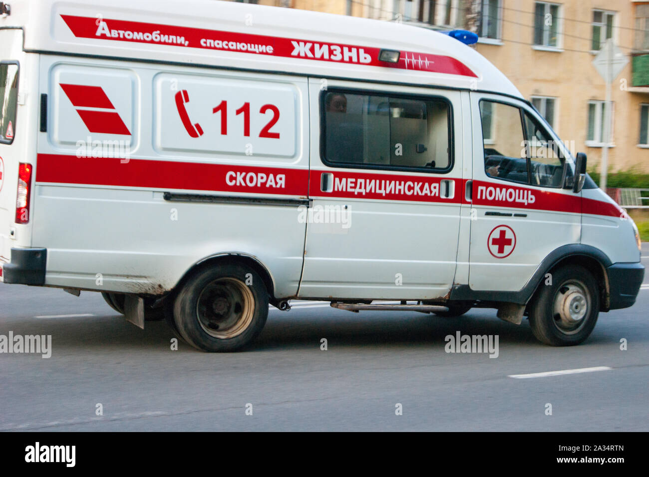 An ambulance car rides around the city. It s written on a car ...