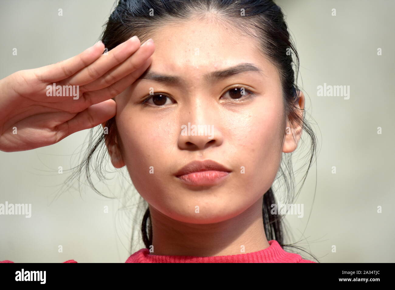 A Saluting Beautiful Minority Female Stock Photo - Alamy