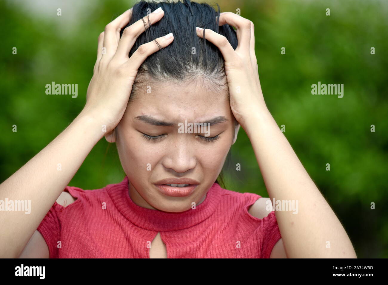A Stressed Young Asian Person Stock Photo - Alamy