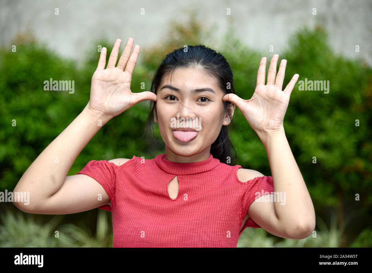 Young Asian Girl Making Funny Faces Stock Photo - Alamy