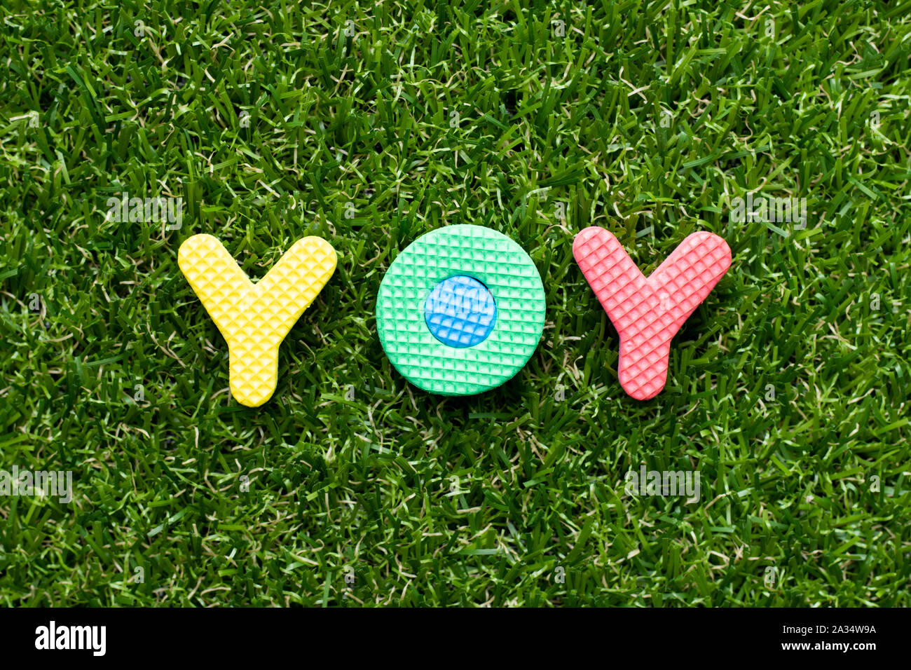 Toy foam letter in word YOY (abbreviation of year over year) on green ...