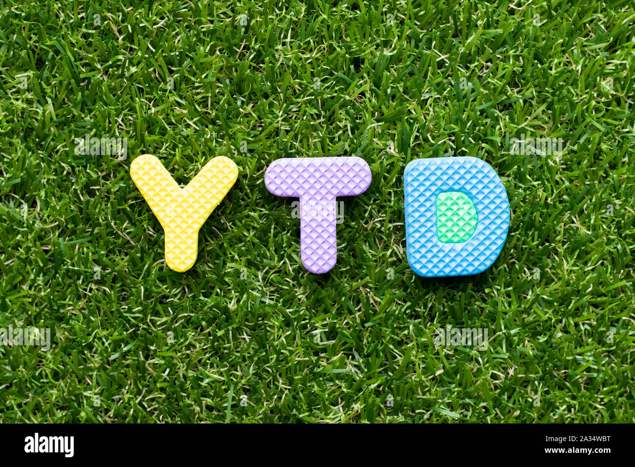 Toy foam letter in word YTD (abbreviation of year to date) on green ...