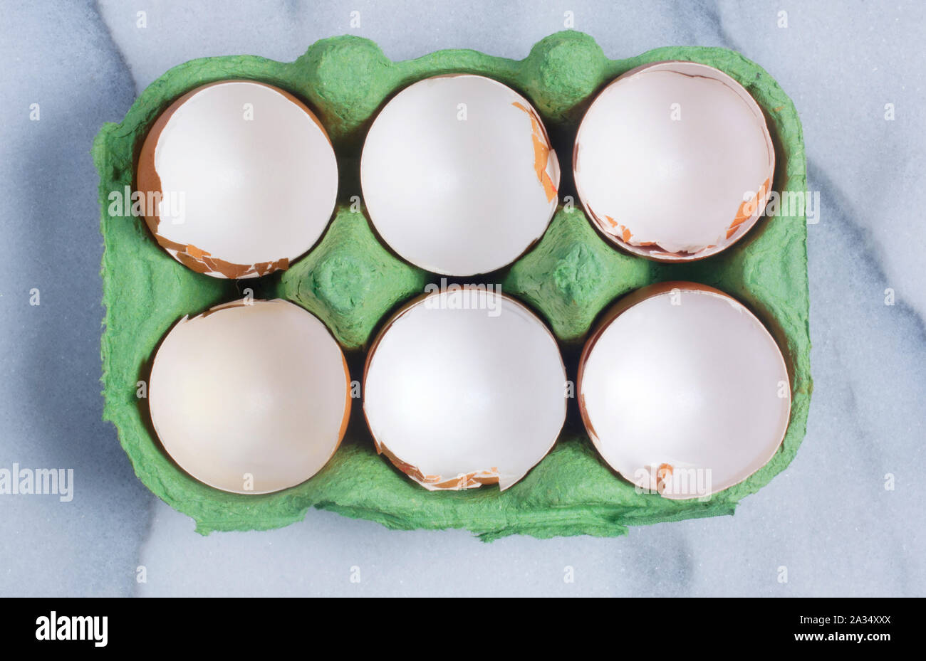 Studio shot of cracked, empty chicken egg shells in an egg box on a ...