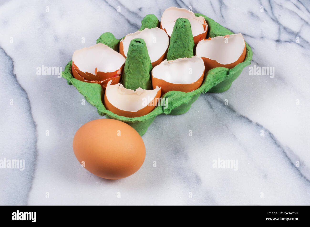 Studio shot of cracked, empty chicken egg shells in an egg box on a ...