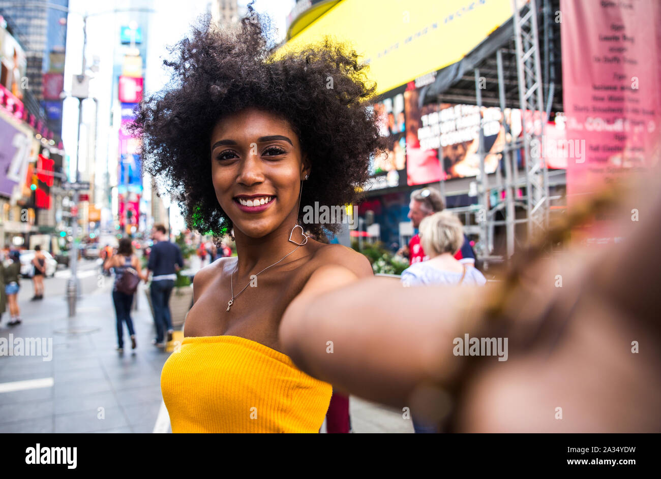 Young beautiful girl walking in Time square, manhattan. Lifestyle ...
