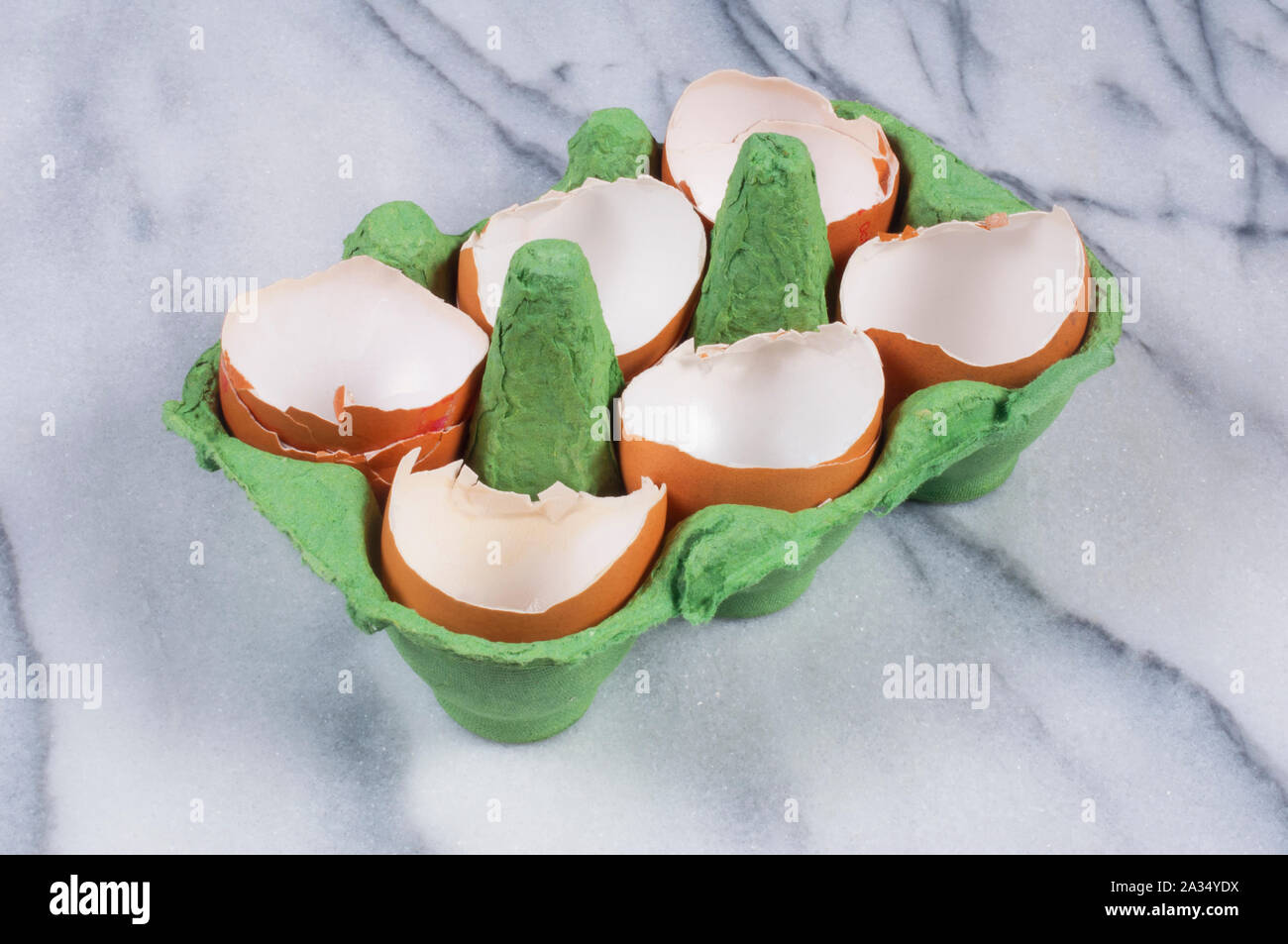 Studio shot of cracked, empty chicken egg shells in an egg box on a ...