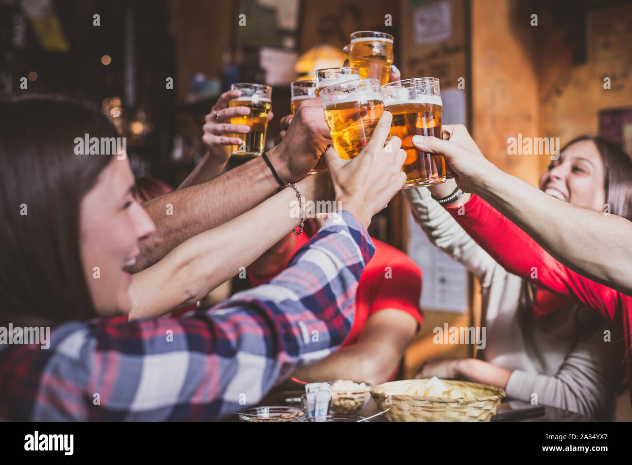 Group of teens having fun in a pub Stock Photo - Alamy