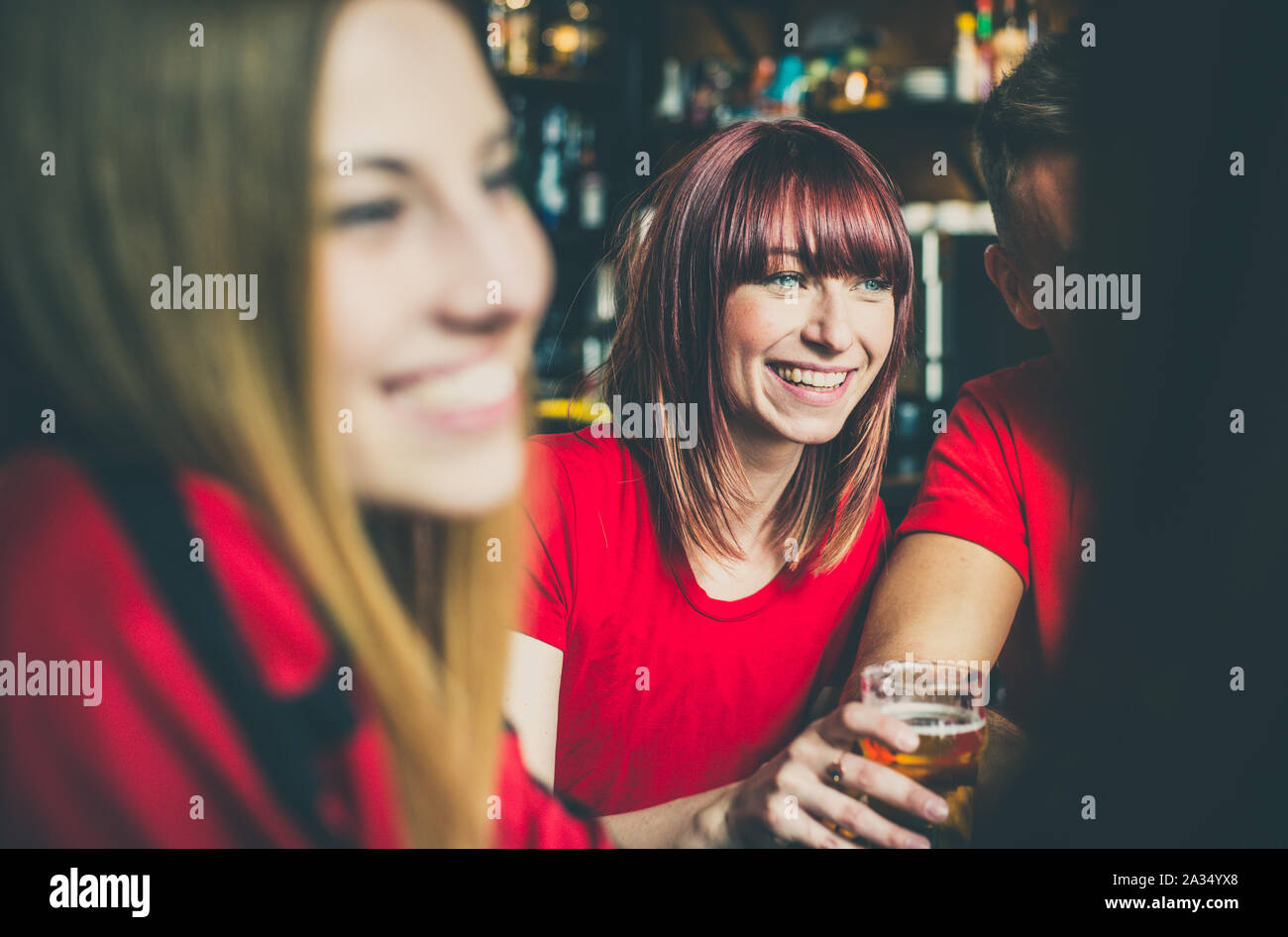 Group of teens having fun in a pub Stock Photo - Alamy