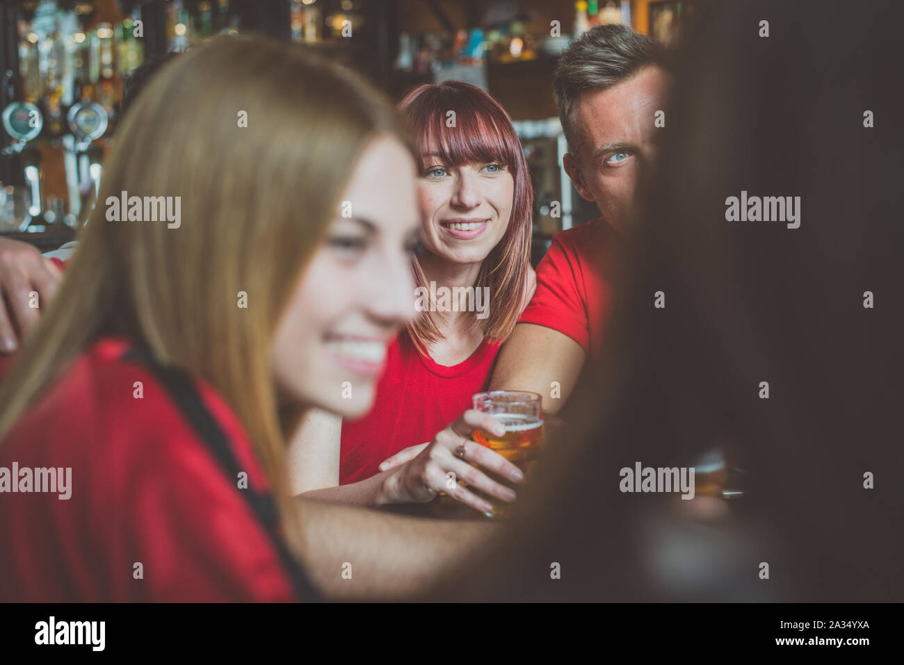 Group of teens having fun in a pub Stock Photo - Alamy