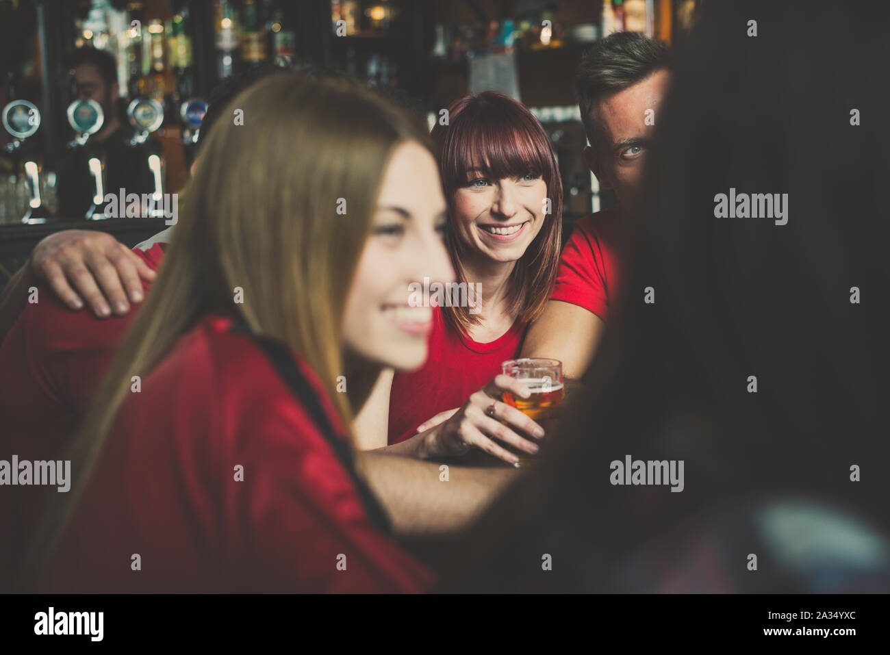 Group of teens having fun in a pub Stock Photo - Alamy