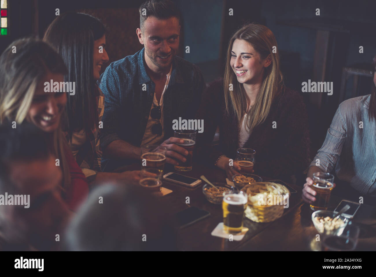 Group of teens having fun in a pub Stock Photo - Alamy