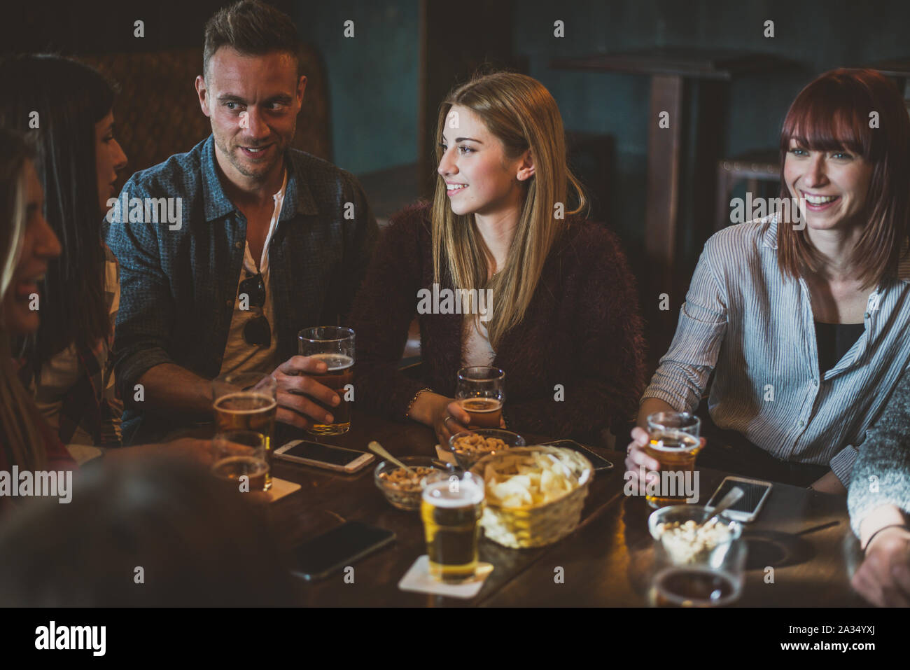 Group of teens having fun in a pub Stock Photo - Alamy