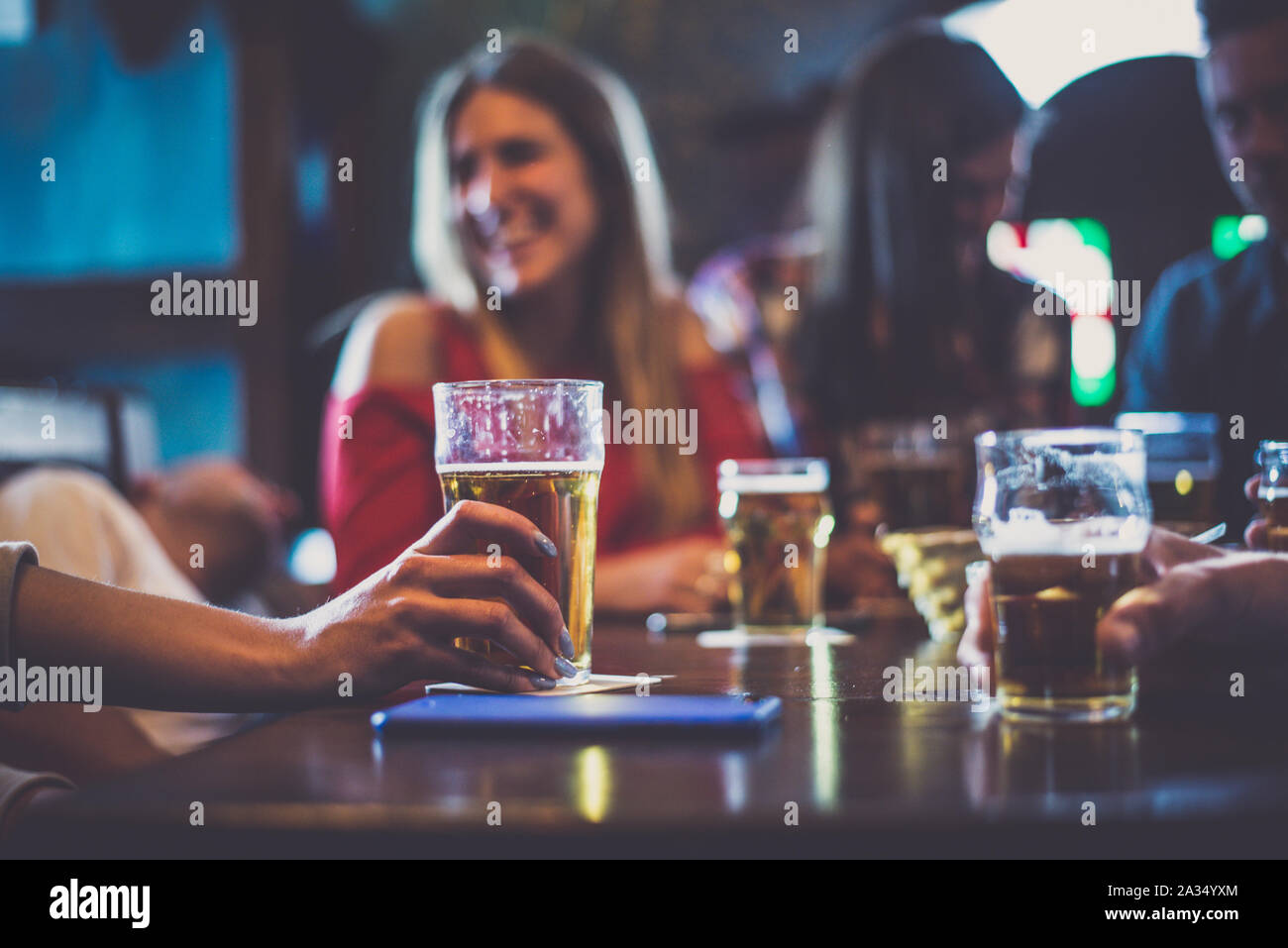 Group of teens having fun in a pub Stock Photo - Alamy