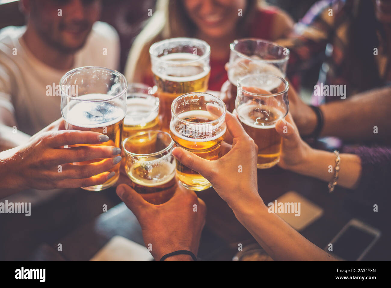 Group of teens having fun in a pub Stock Photo - Alamy