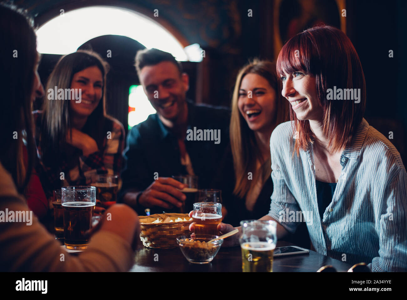 Group of teens having fun in a pub Stock Photo - Alamy