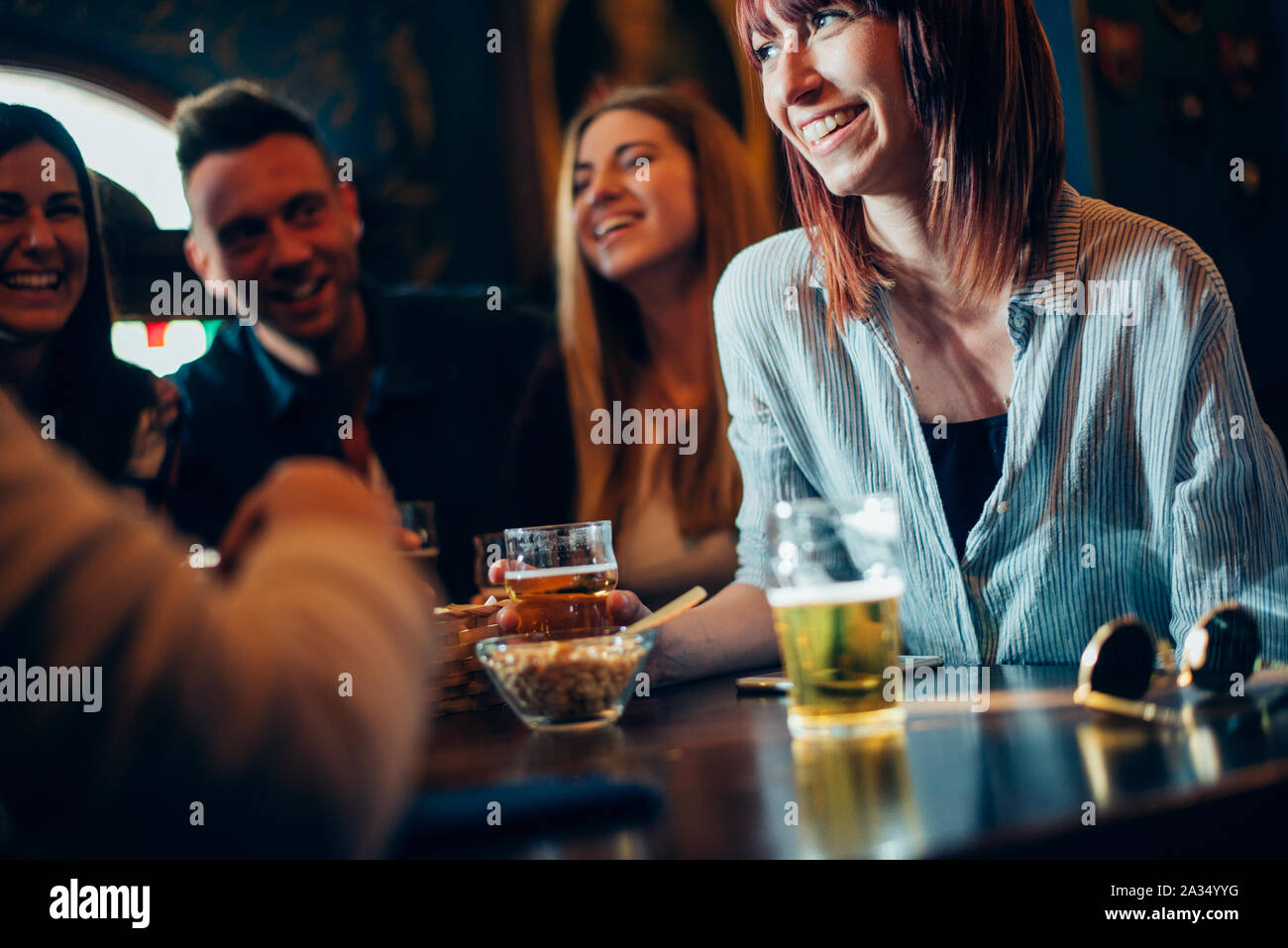 Group of teens having fun in a pub Stock Photo - Alamy
