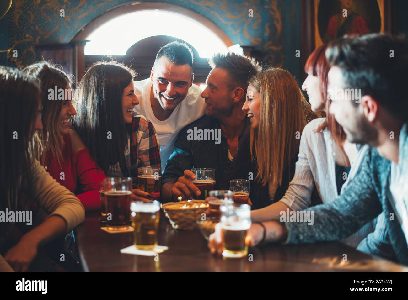 Group of teens having fun in a pub Stock Photo - Alamy